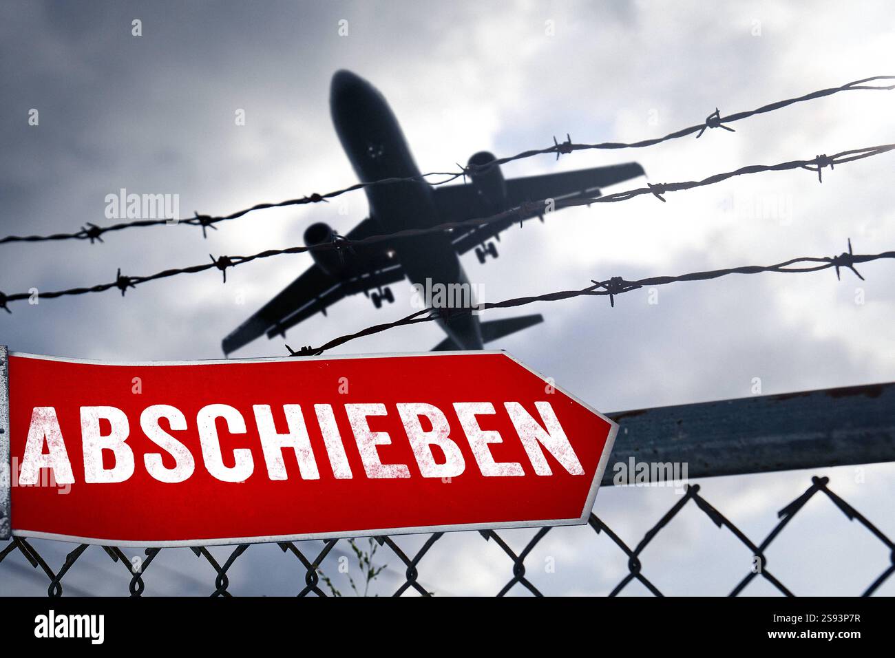 January 24, 2025: Airplane flies behind a barbed wire fence with a sign ...