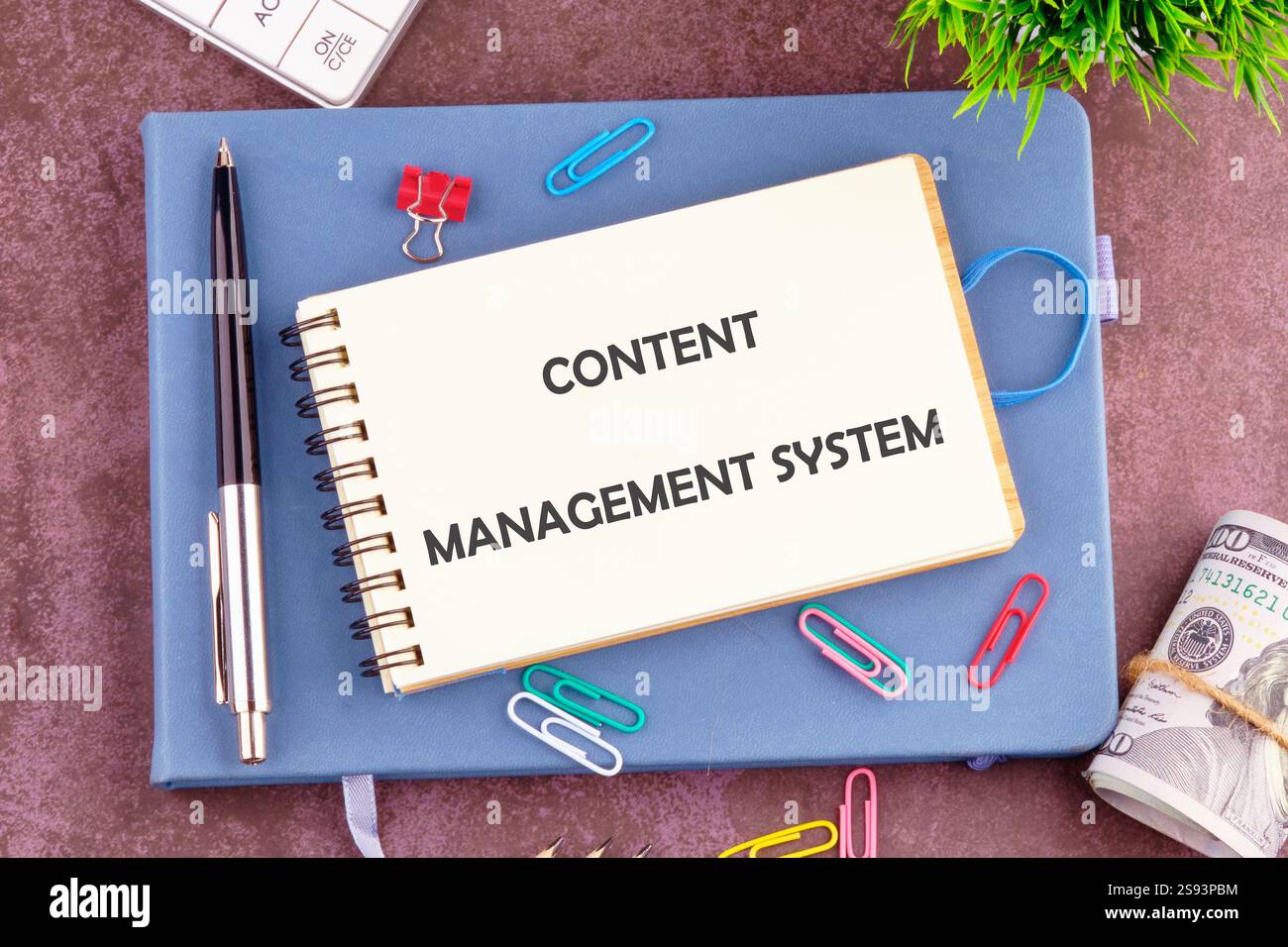 Desk setup features a notepad labeled content management system ...