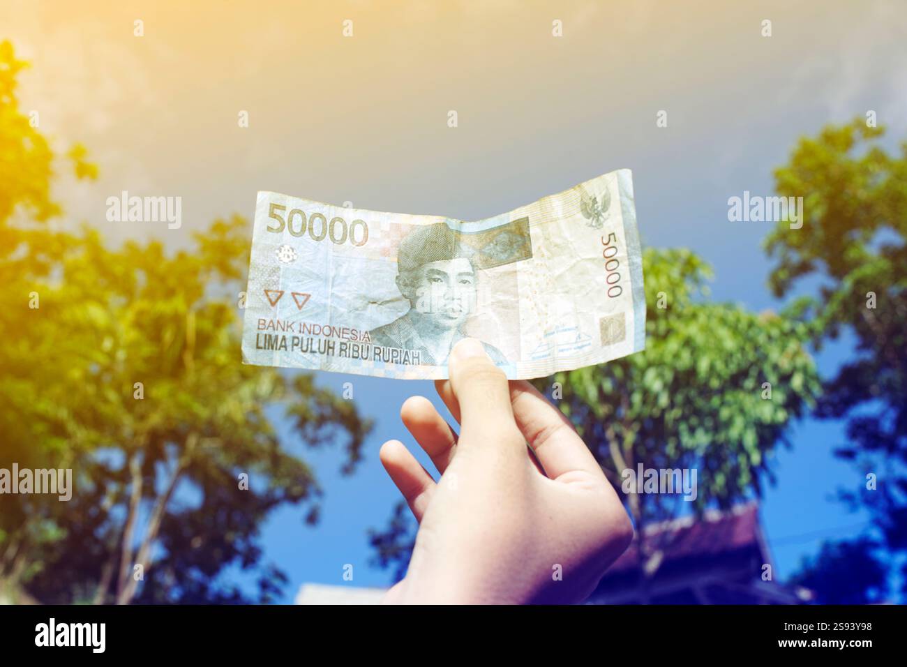 fifty thousand rupiahs. money from Indonesia is held by women Stock ...