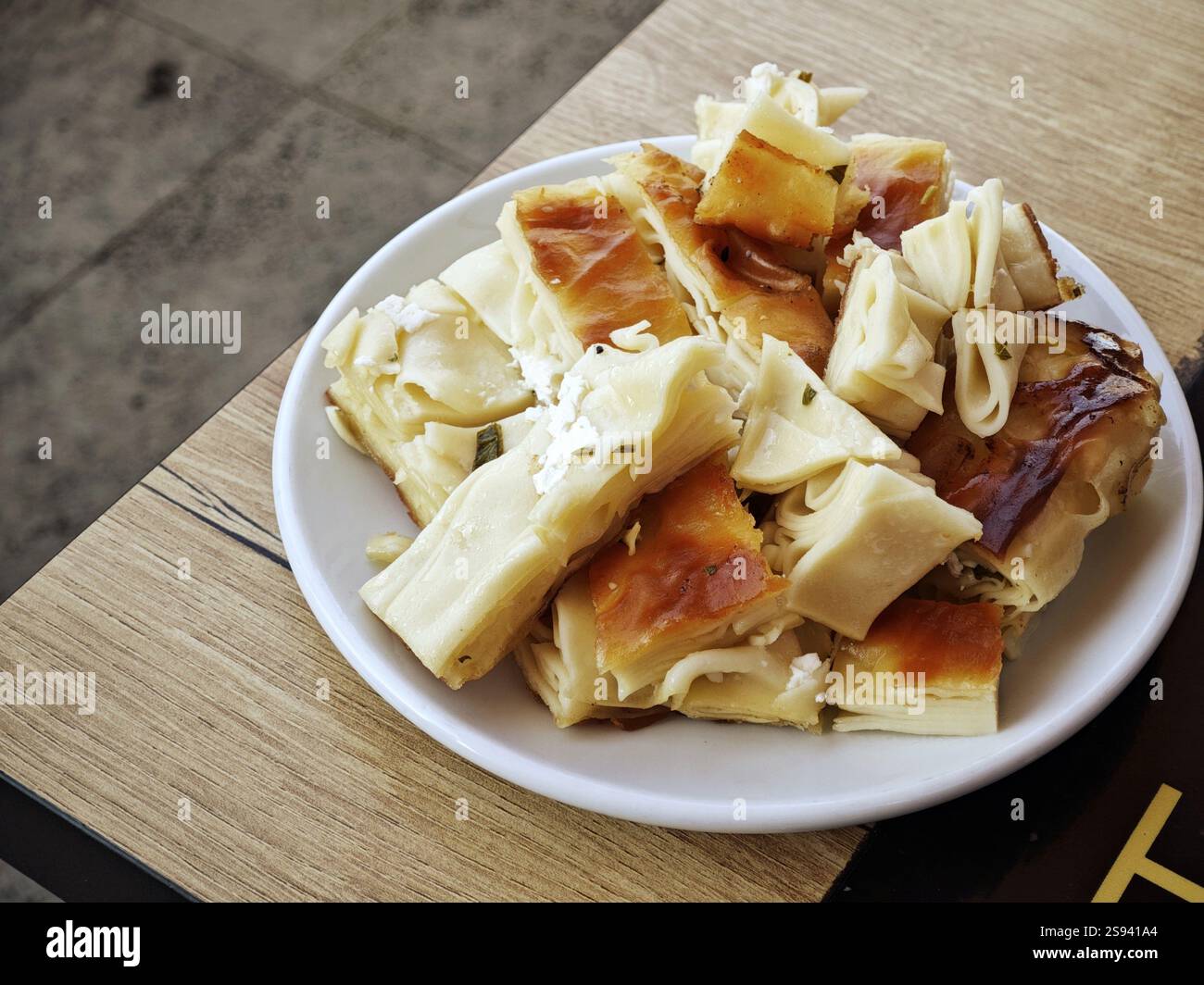 The traditional Turkish dish, su böreği, is filled with a mixture of ...