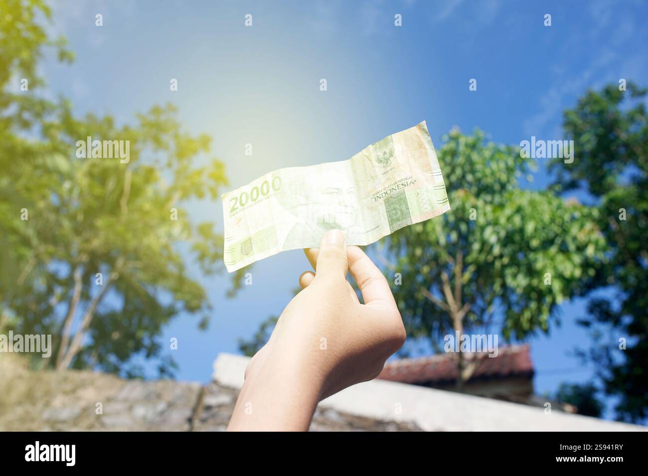 the concept of giving light to Indonesian money Stock Photo - Alamy