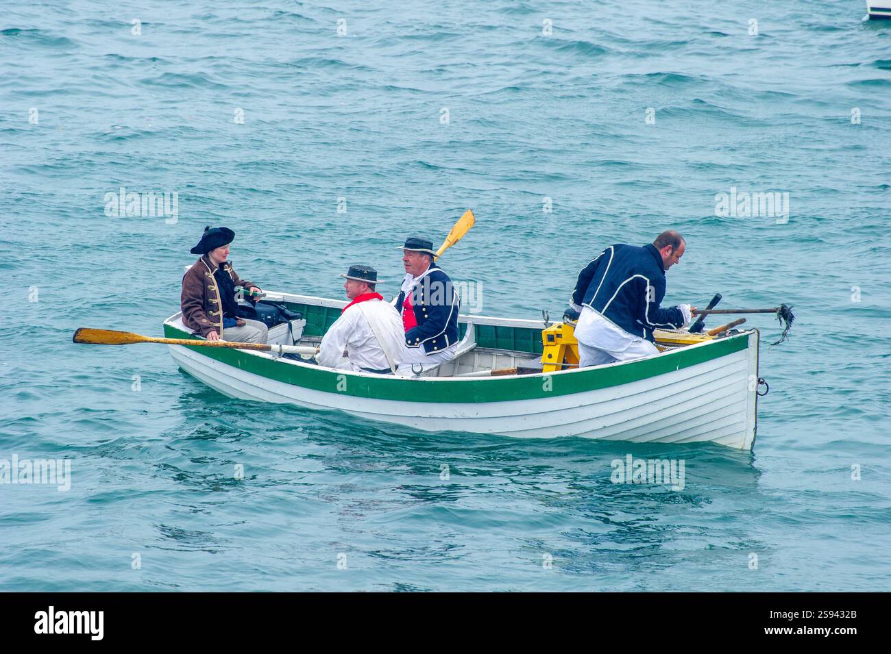 Local people in period costume in a dinghy on Moelfre's annual Lifeboat ...