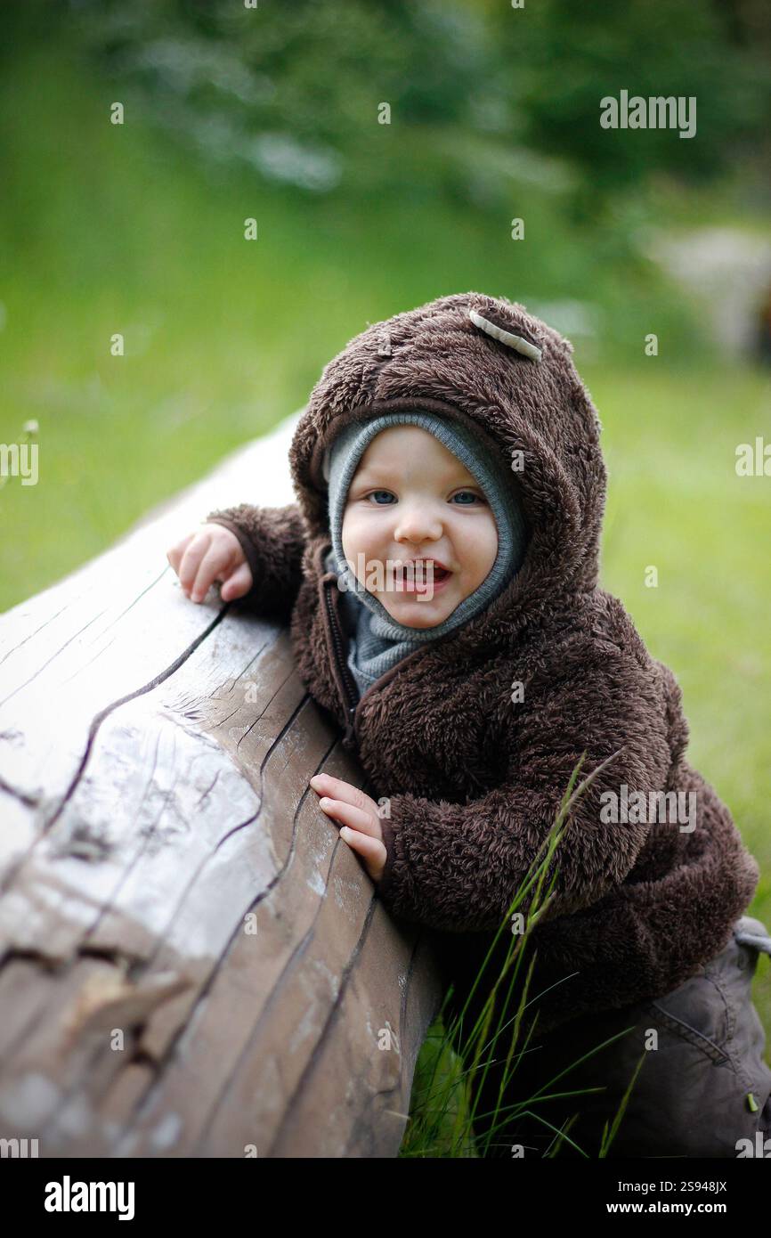 Boy leaning against tree hi-res stock photography and images - Alamy