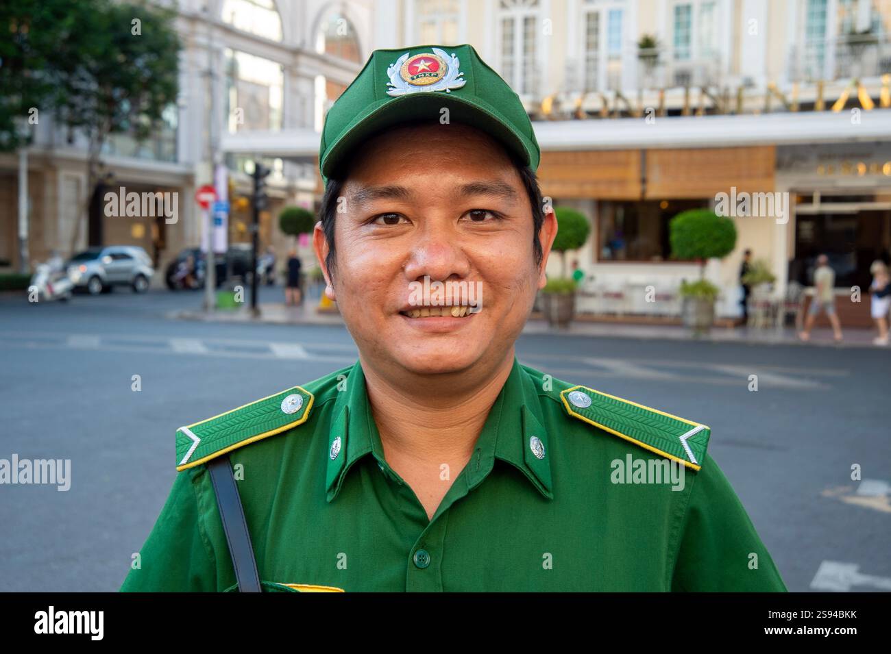 Portrait of a smiling Vietnamese security guard outside the continental ...