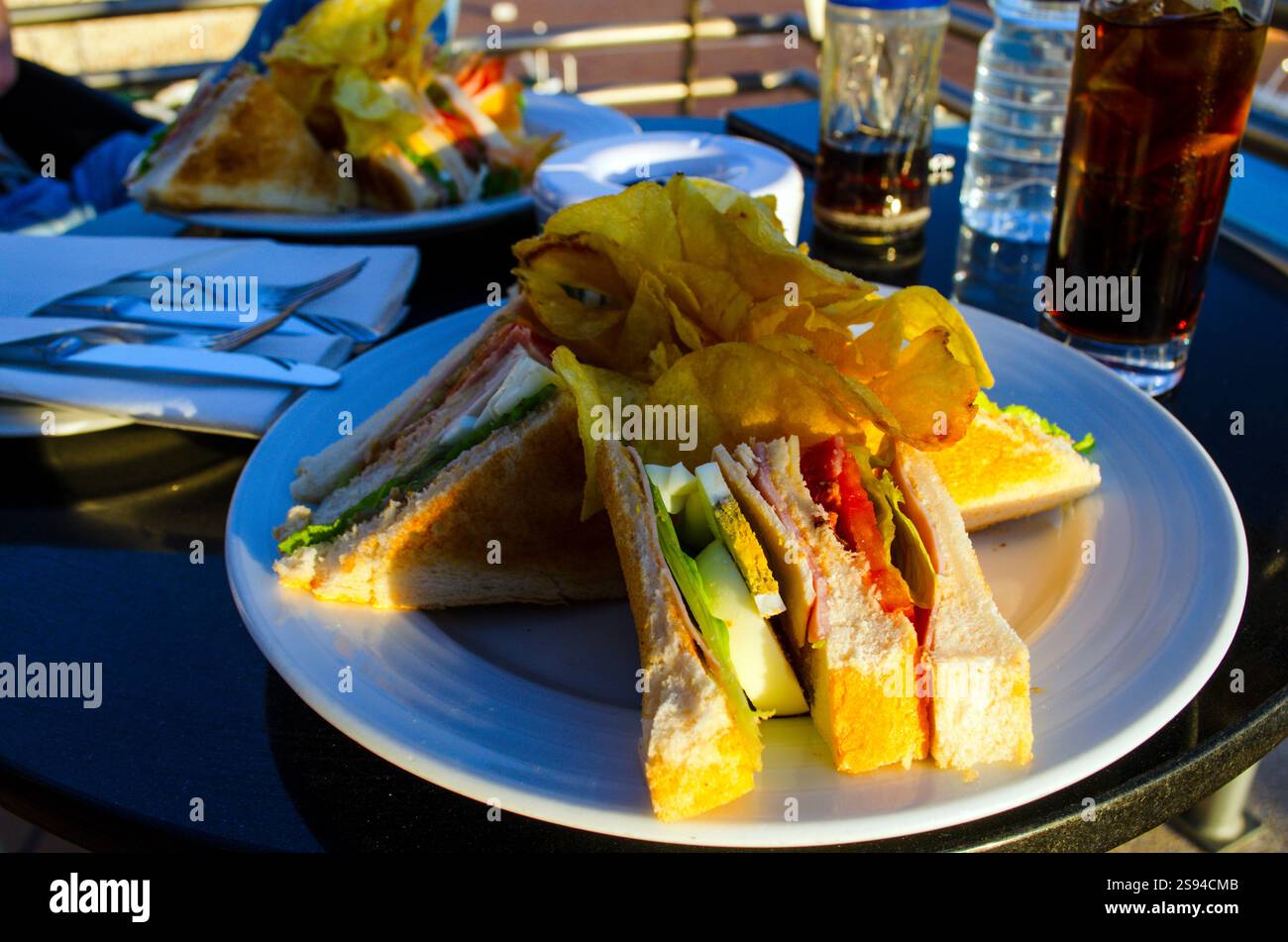 Atmosphere by the beach. Having a sandwich lunch Stock Photo - Alamy