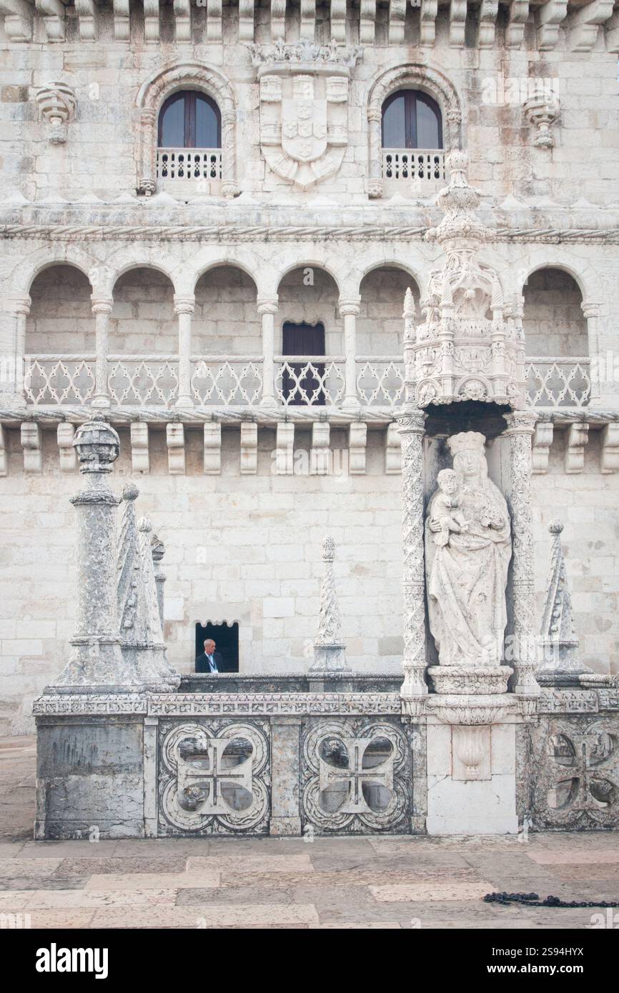 Tourist looks out a window in the ornate Belem Tower, Lisbon, Portugal ...