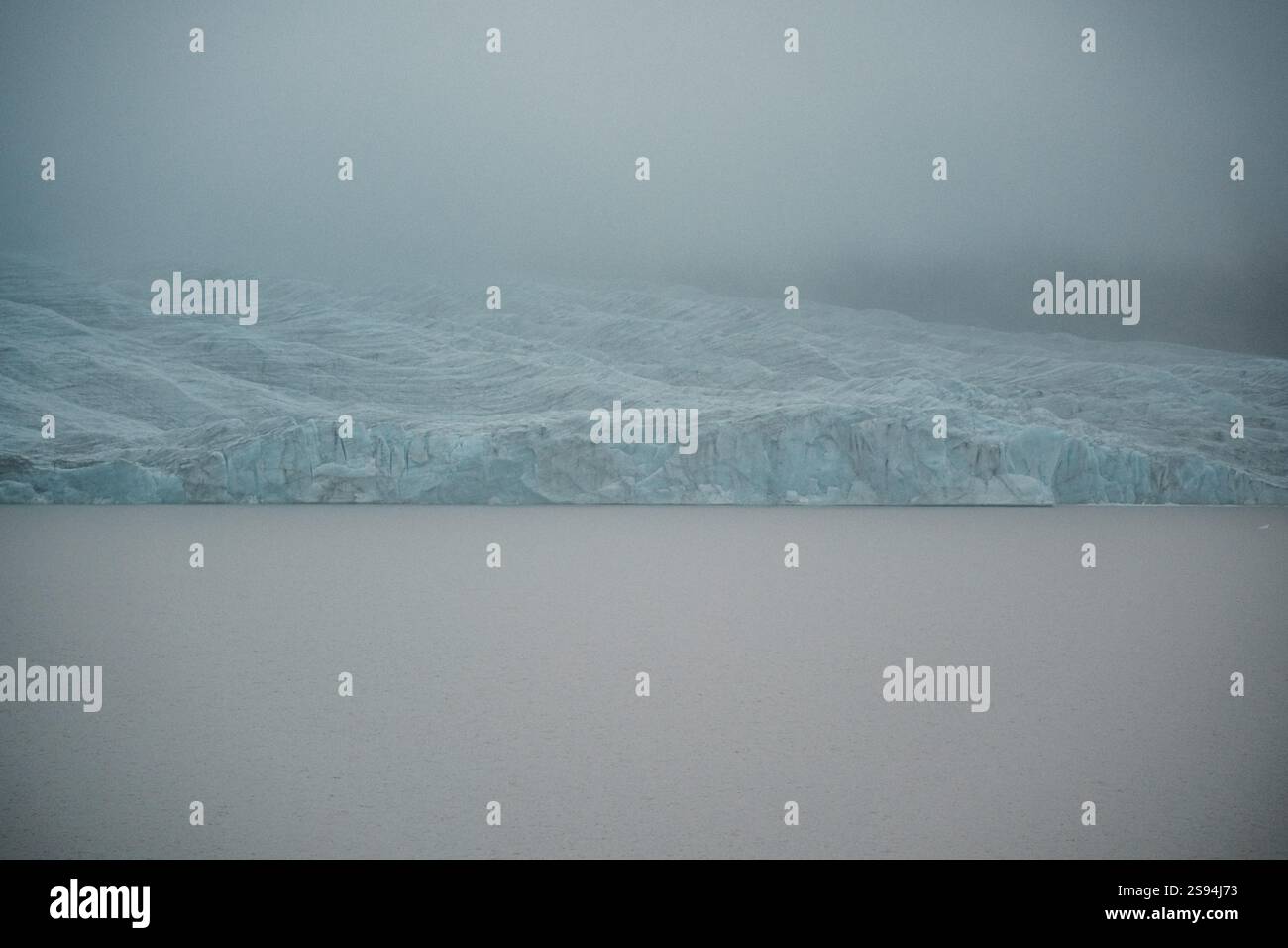 The striking blue ice of Fjallsárlón glacier lagoon on a foggy day in ...