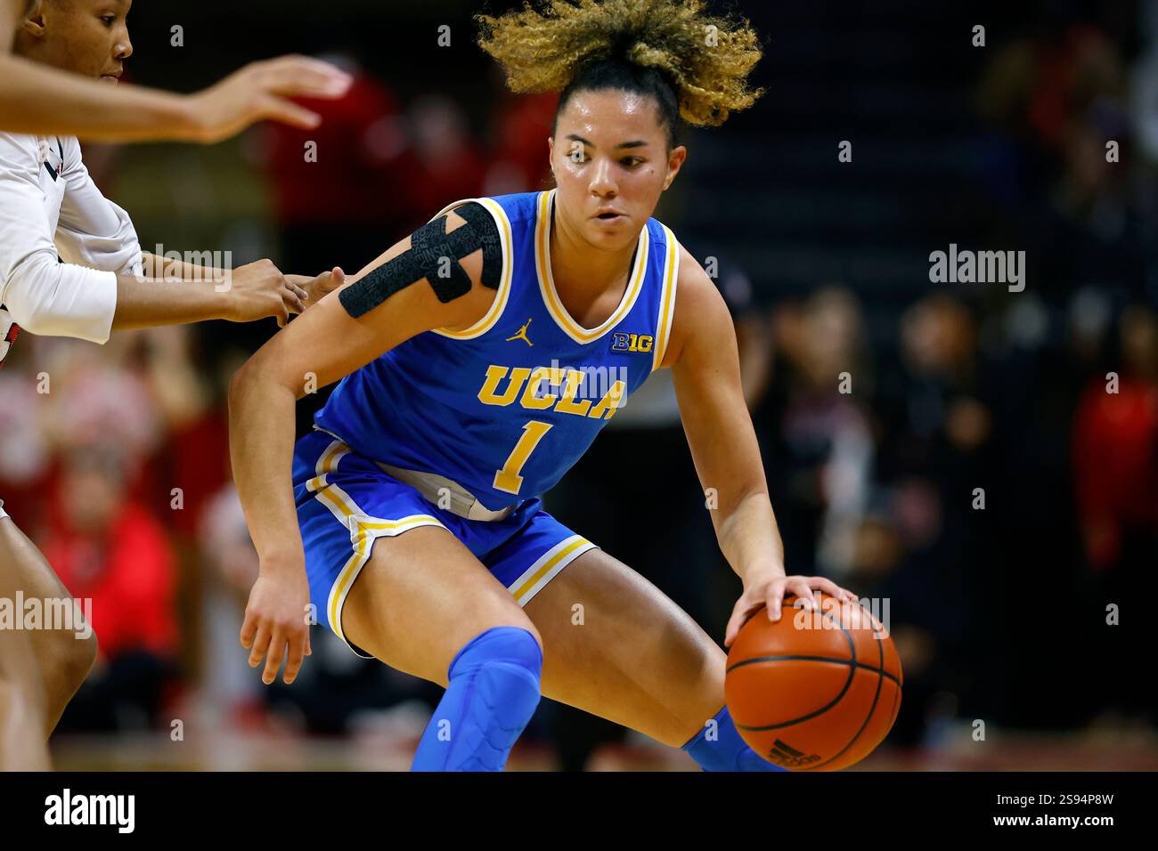 UCLA guard Kiki Rice (1) drives to the basket against Rutgers during ...