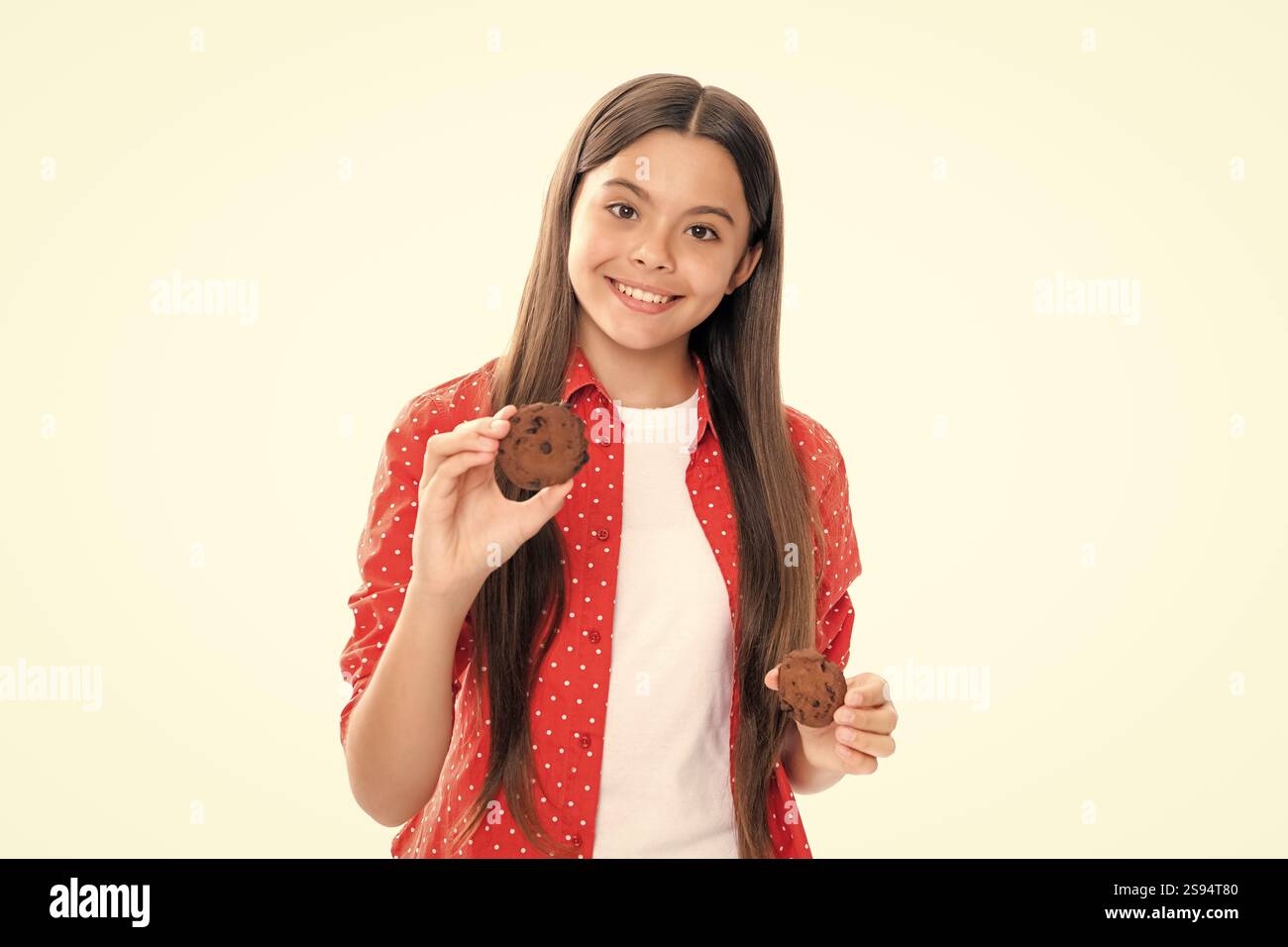 Teenage girl eating cookie or biscuit, isolated on white background ...