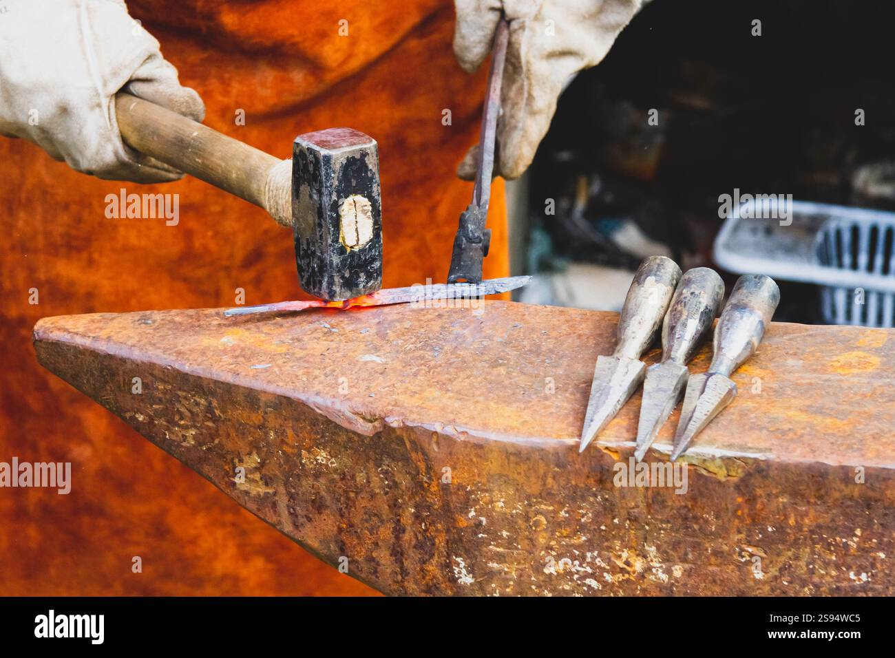 A blacksmith forges iron. Blacksmith's workshop. Blacksmith's anvil and ...