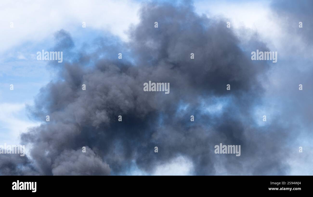 Thick black smoke rising from a blazing fire, creating a dramatic and ...
