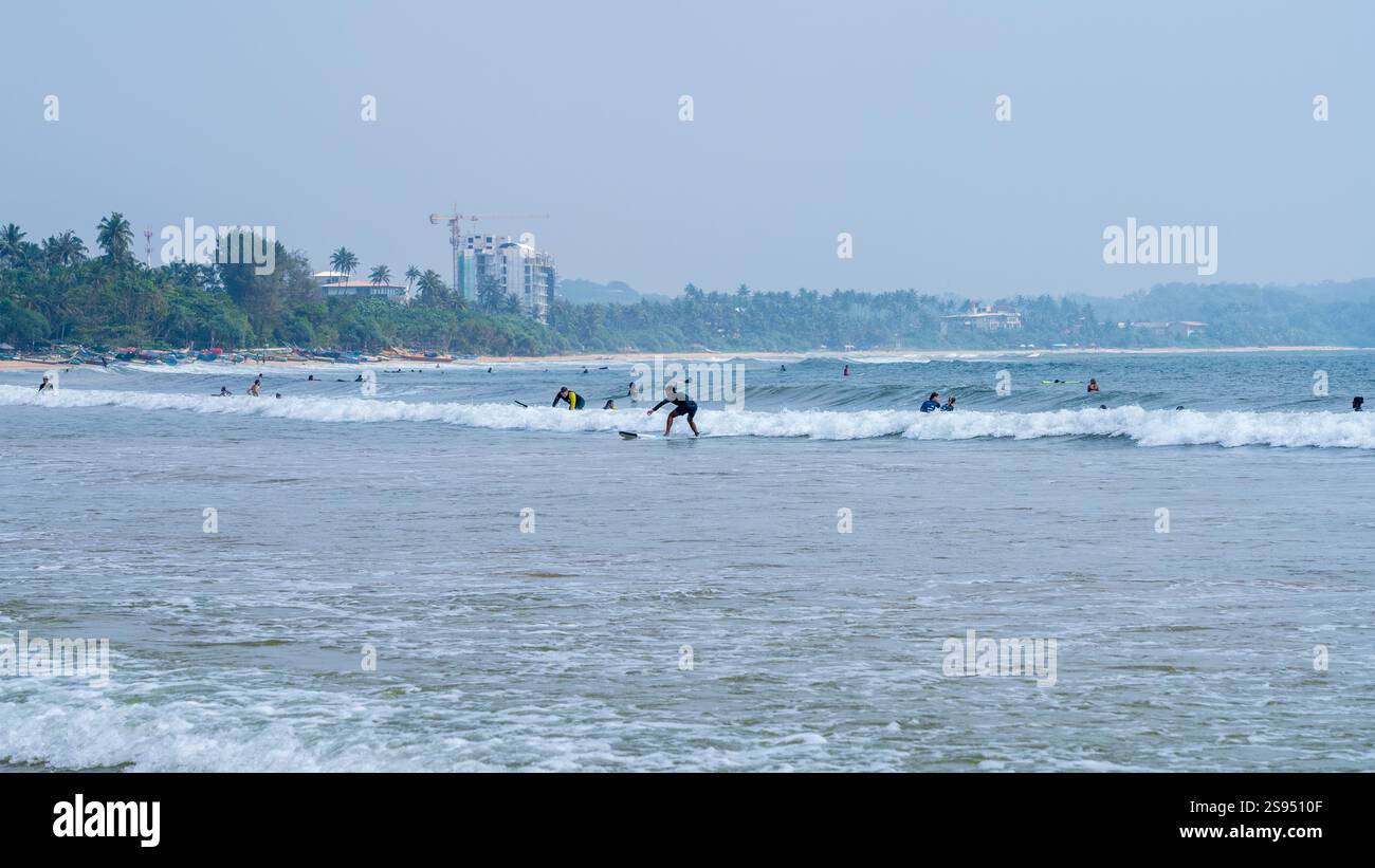 Weligama, Sri Lanka—January 18, 2025:Surfer enjoying the waves at Weligama Beach, a renowned ...