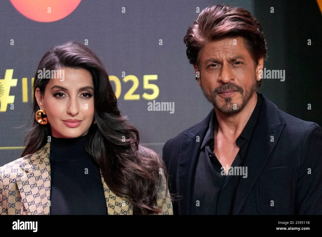 Bollywood actor Shah Rukh Khan and actress Nora Fatehi pose during a ...