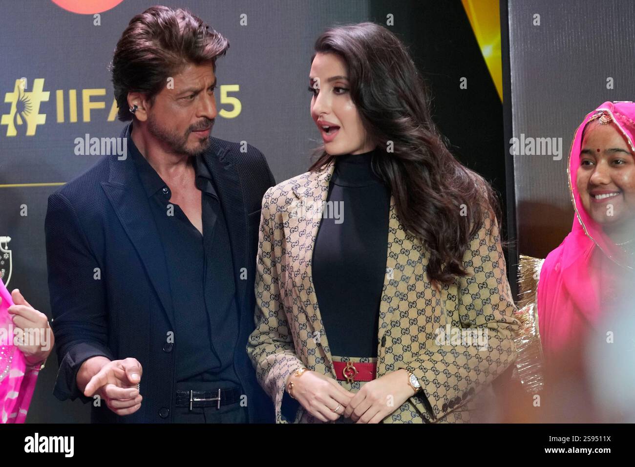Bollywood actor Shah Rukh Khan speaks with actress Nora Fatehi during a ...