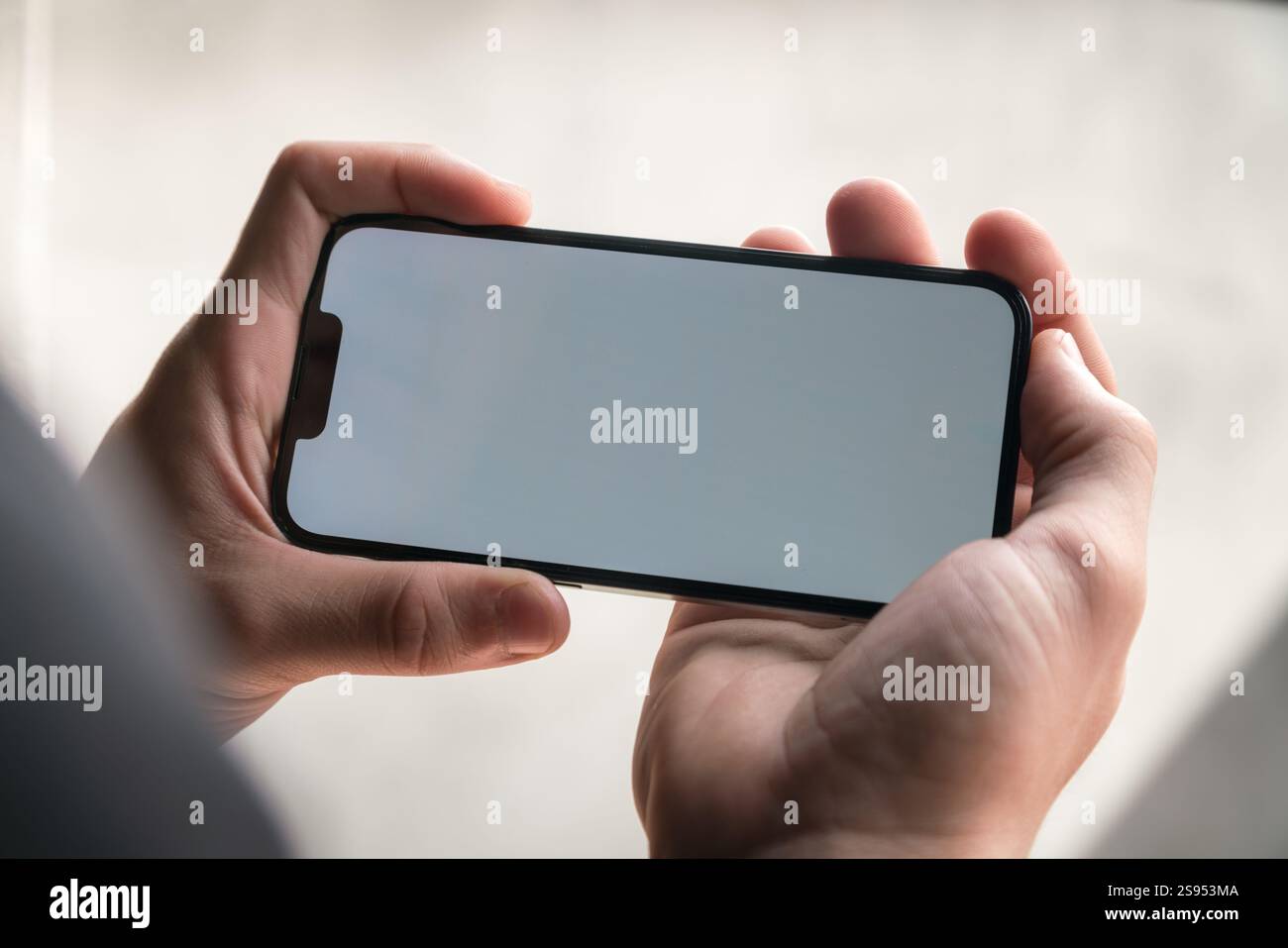 Close-up of a male hand swiping and tapping a mobile horizontally, with ...
