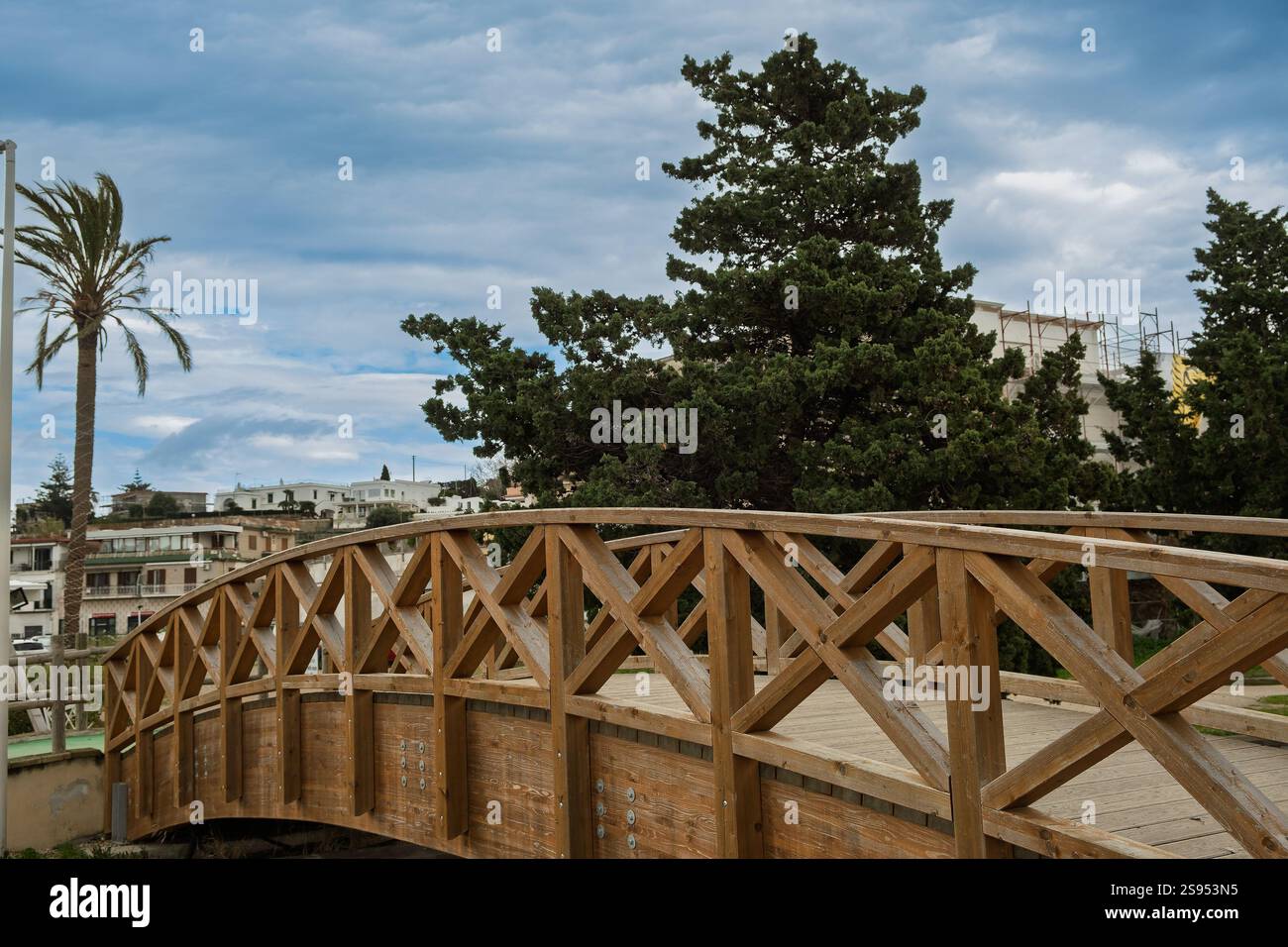 This photo captures a charming wooden bridge with a rustic design ...