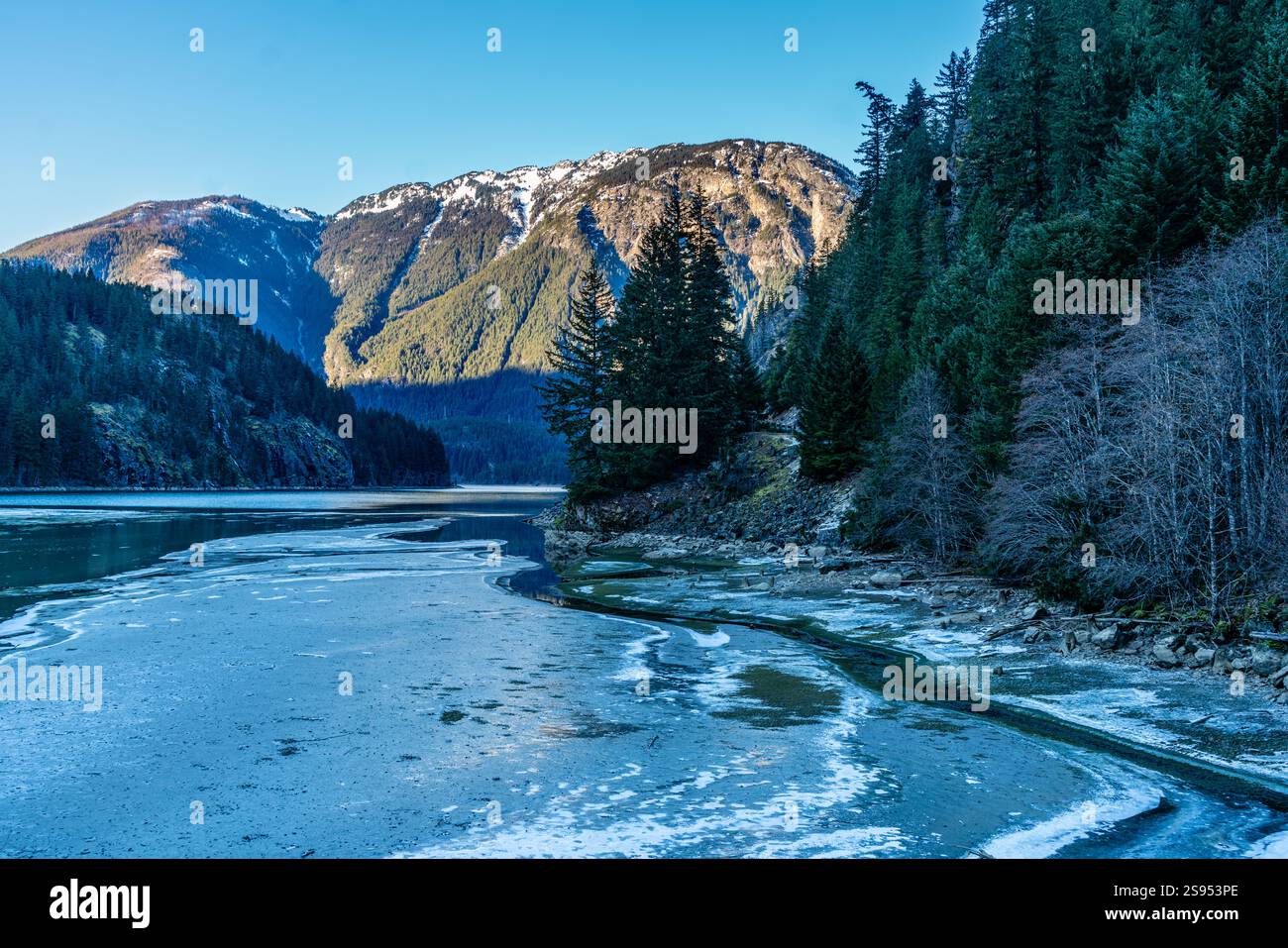 A landscape shot of the Skagit River in winter. with a layer of ice on ...