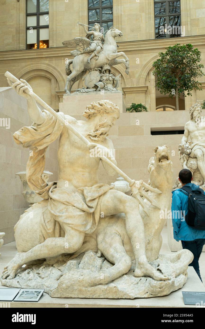 White marble sculpture of man spearing an animal, Louvre Museum, Paris ...