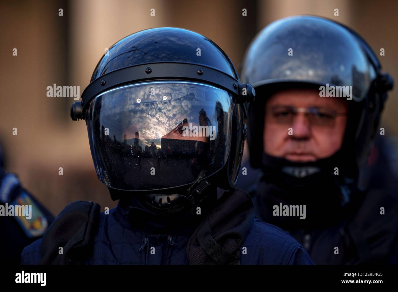 Riot police stand in line during a protest by supporters of Calin ...
