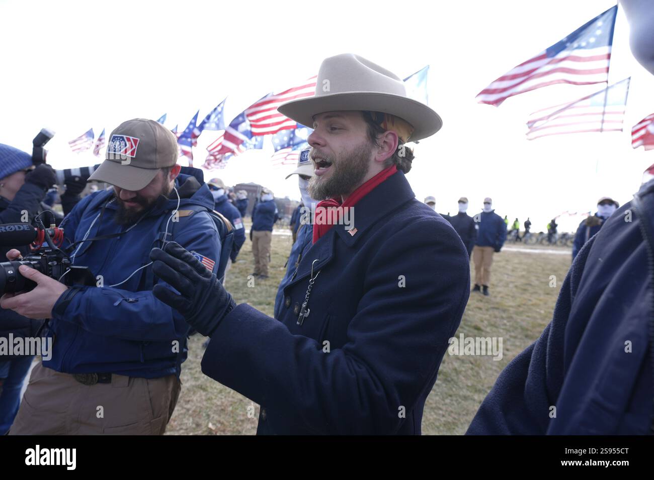 Thomas Ryan Rousseau, center, and members of a group calling themselves ...