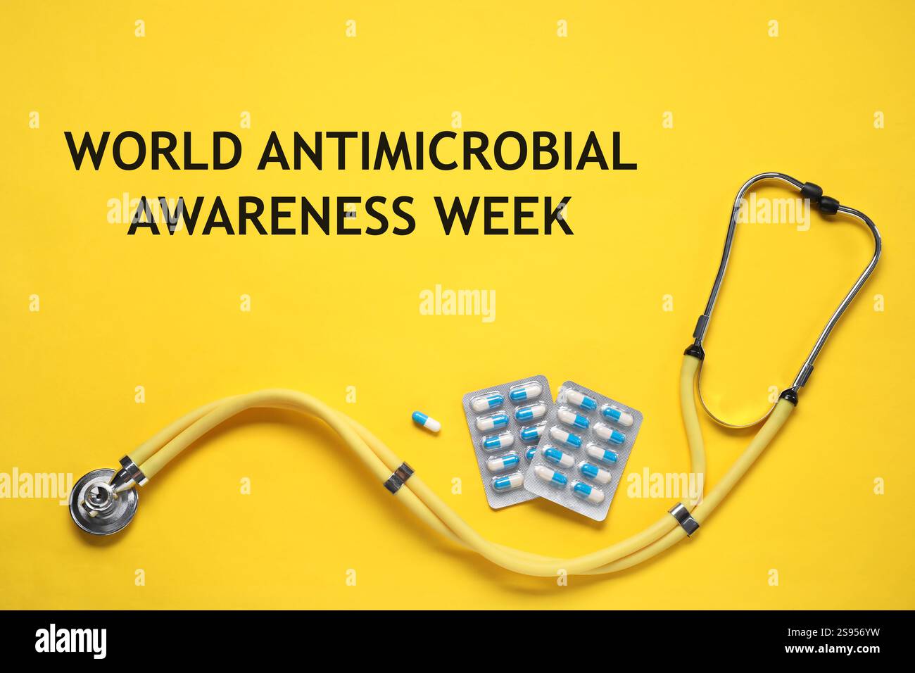 World antimicrobial awareness week. PIlls and stethoscope on yellow ...