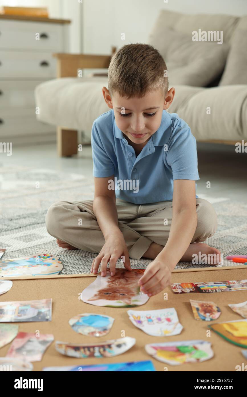 Little boy creating vision board with different pictures and other ...