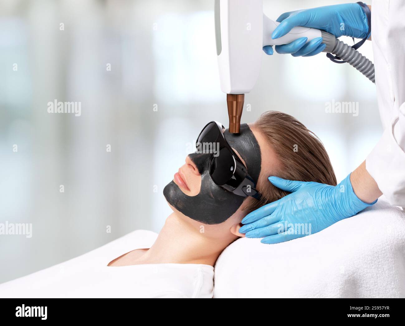 Beautician doing carbon peeling procedure to handsome guy in beauty ...