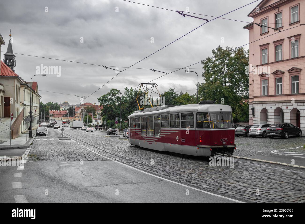Old vintage tourist tram comes through the alley of a Prague city in an ...