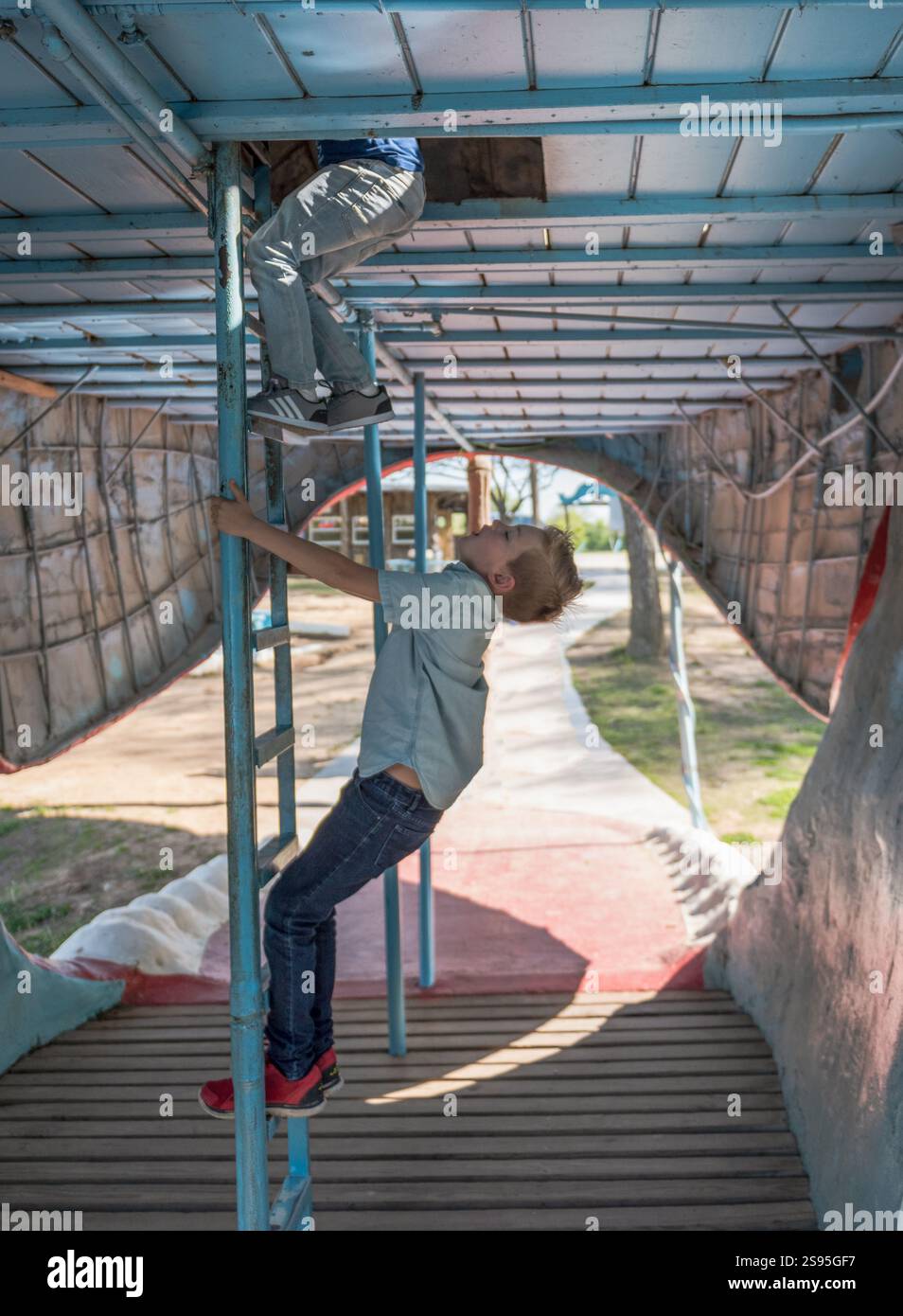 Catoosa, OK USA - April 29, 2018: Boys climbing ladder at iconic Blue ...