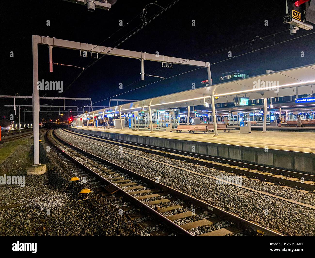 Views from a Large Railway Station's Platform at night during a Commute ...