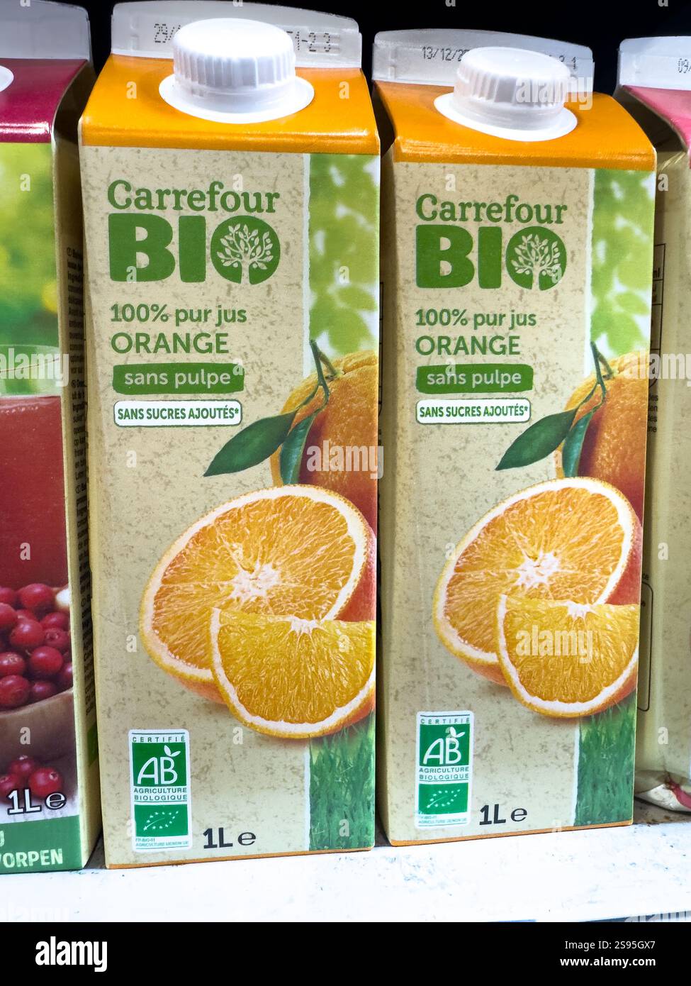 Freshly squeezed orange juice cartons on supermarket shelf in natural ...
