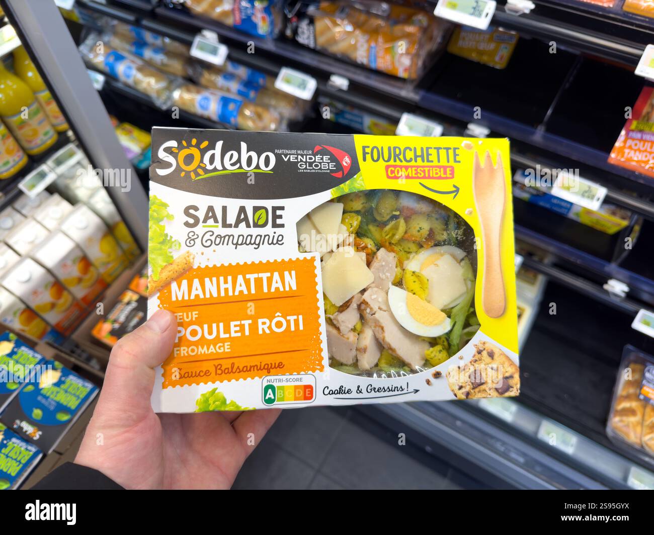 Hand held salad box showcases fresh ingredients in vibrant grocery ...