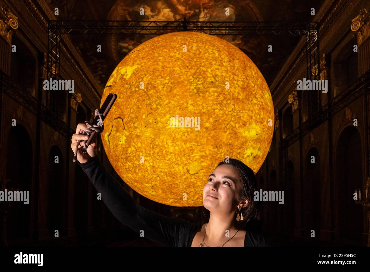 London, UK. 24 January 2025. A staff member with ‘Helios’ by artist ...