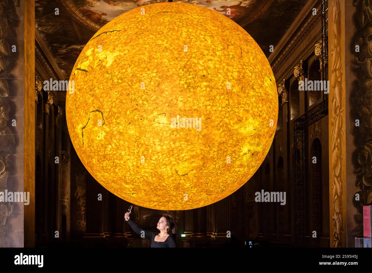 London, UK. 24 January 2025. A staff member with ‘Helios’ by artist ...