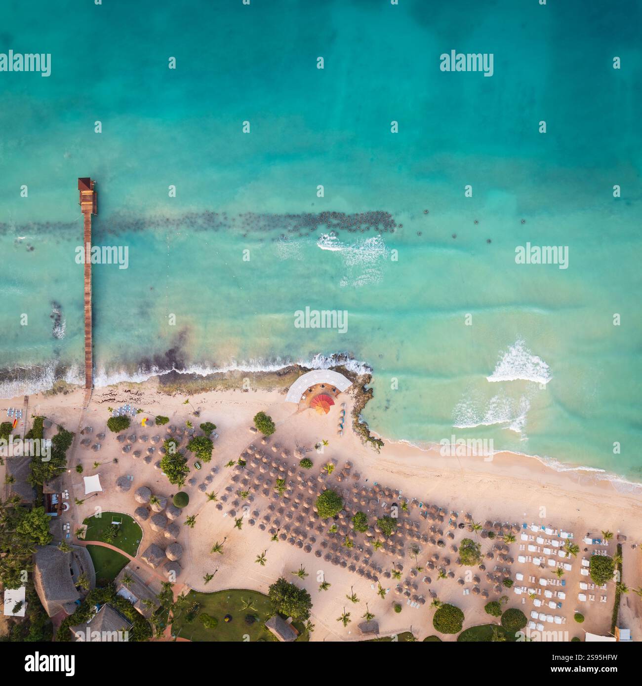 Birds eye view of a Bayahibe beach with palms,pier and a lighthouse in ...