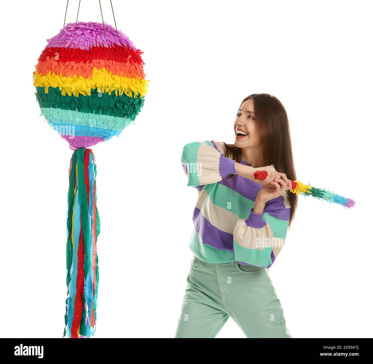 Happy woman breaking colorful pinata with stick on white background ...