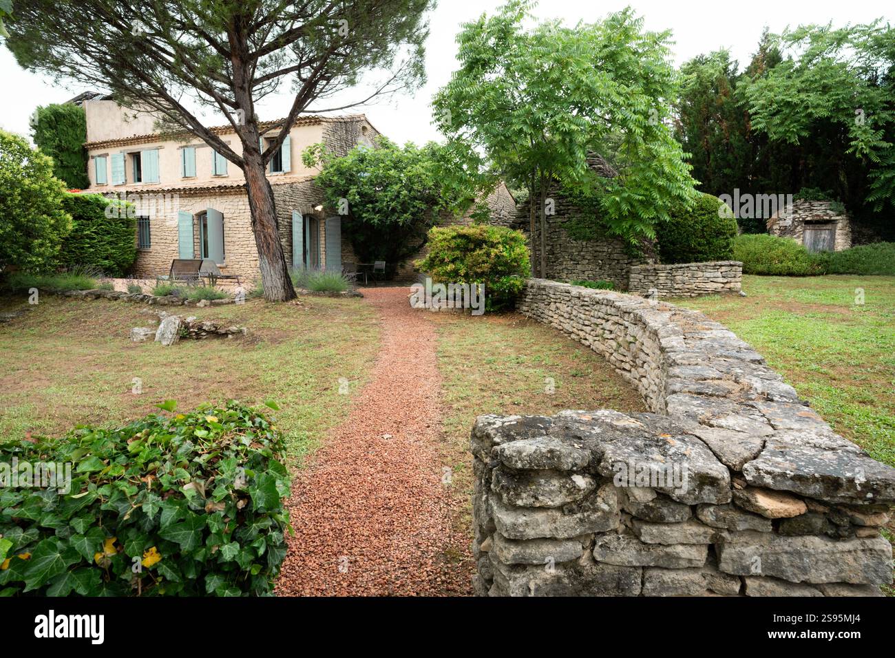 Traditional Provencal home with blue shutters and a stone borie i nthe ...