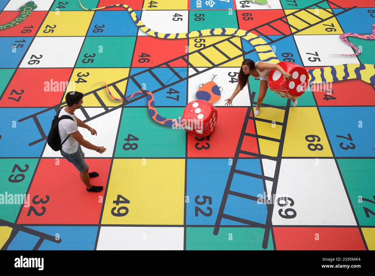 Tourists play a game of Snakes and Ladders at a Chinese temple ahead of ...