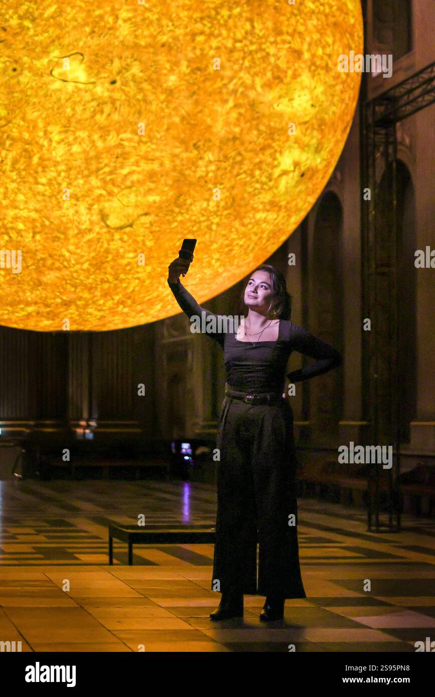 London, UK, 24th Jan 2025. Staff with the installation. The new 'Helios ...