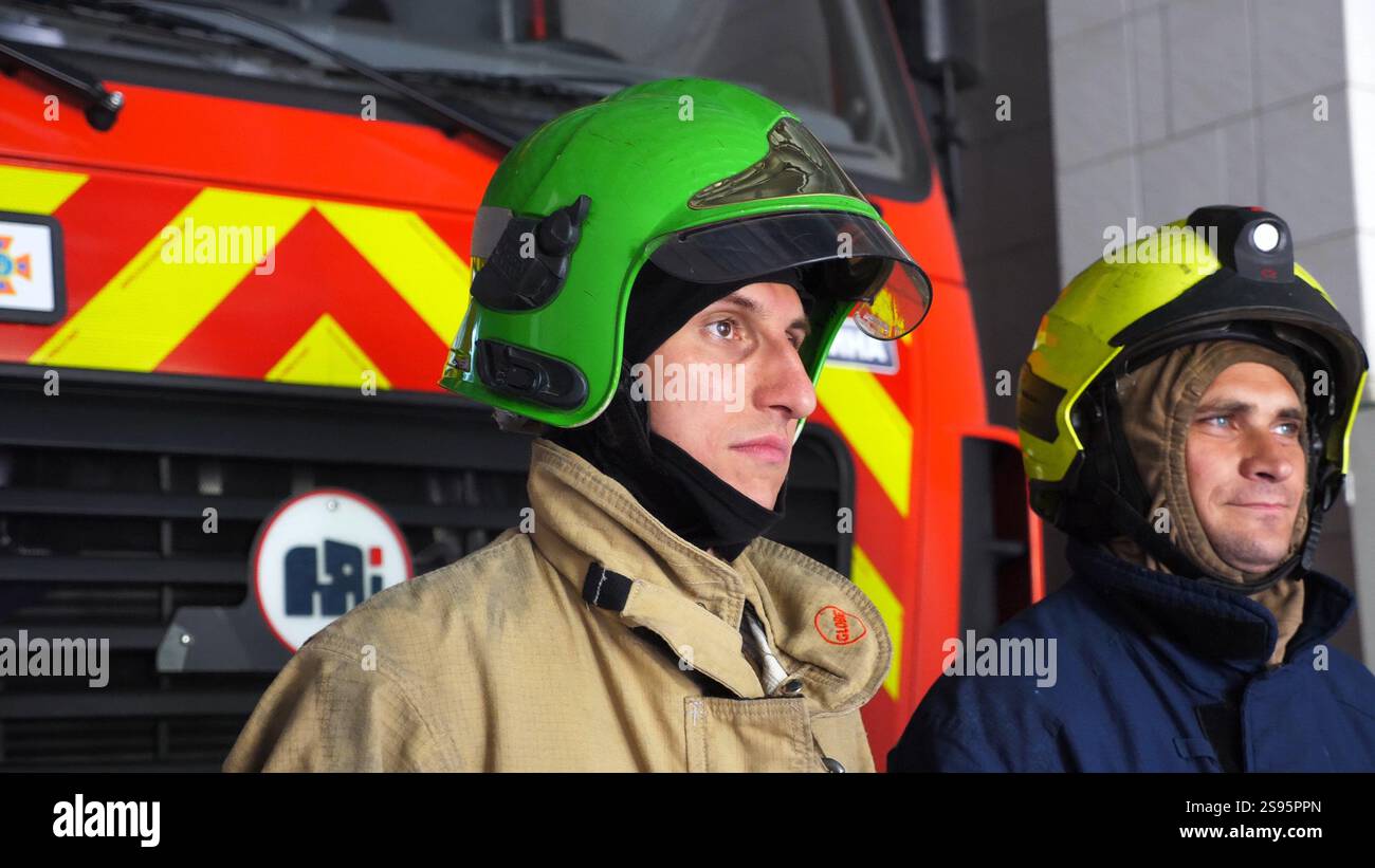 Portrait of male firefighters in helmets and protective uniforms ...