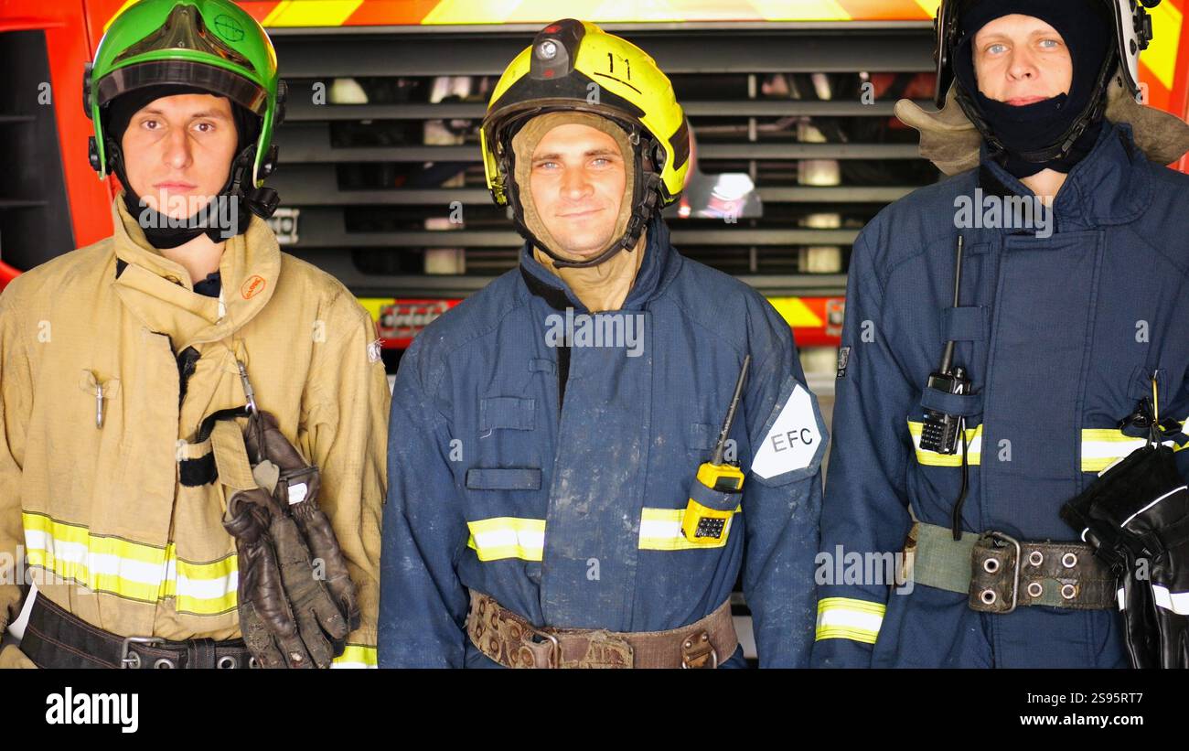 Portrait of male firefighters in helmets and protective uniforms ...