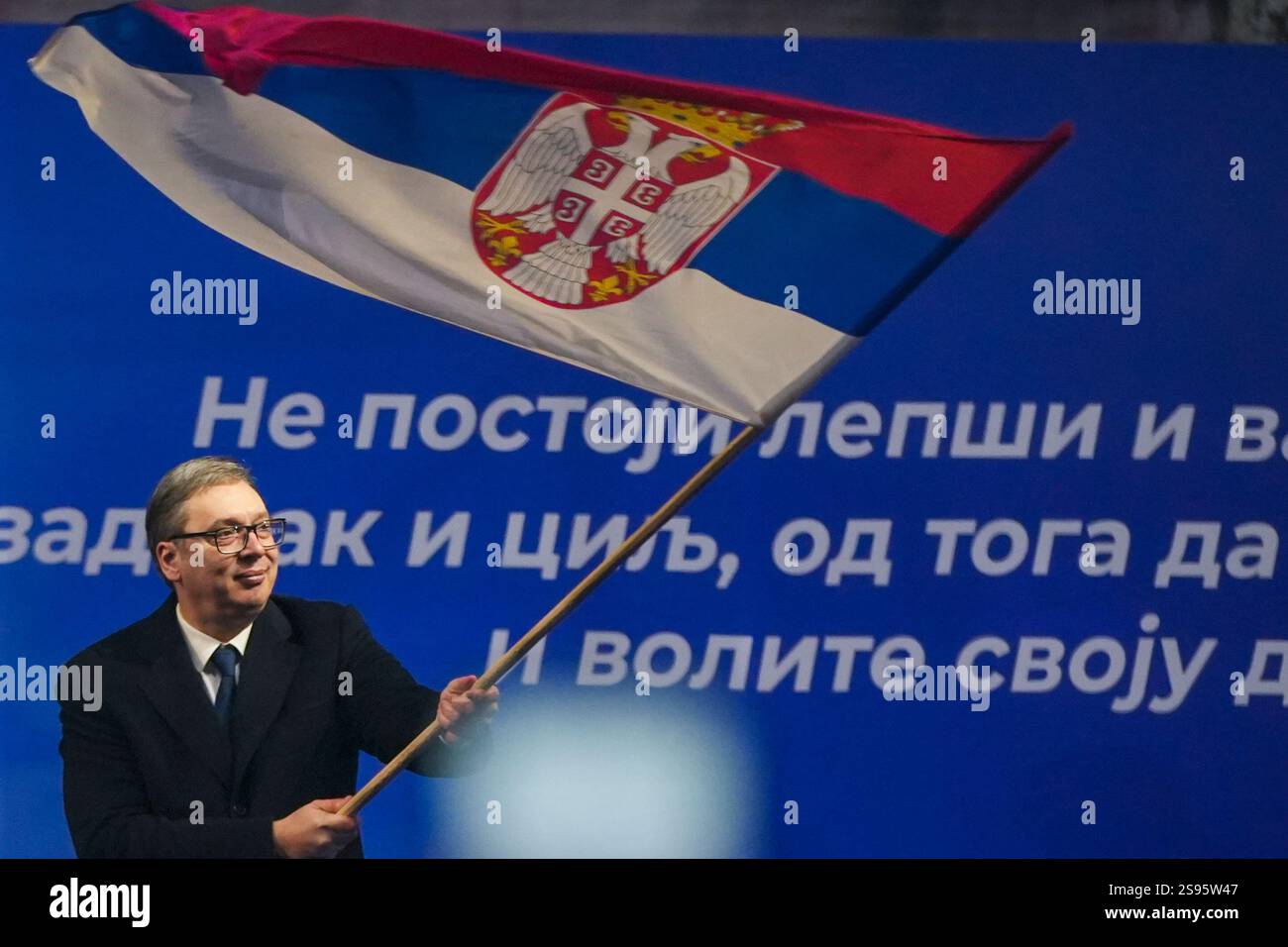 Serbian President Aleksandar Vucic waves a Serbian flag after a rally ...