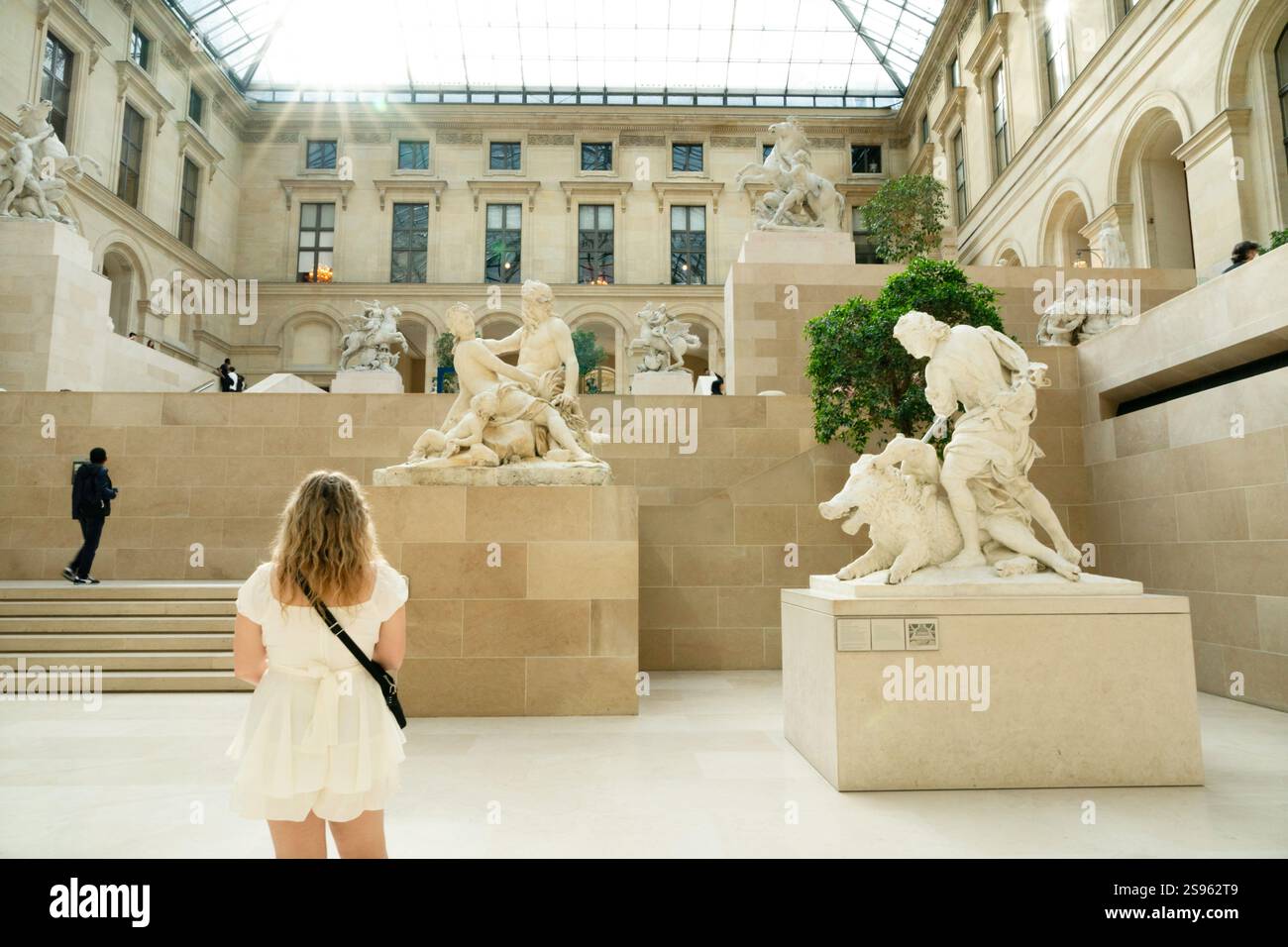 Tourists admiring the marble statues in the Sculpture Garden, Louvre ...