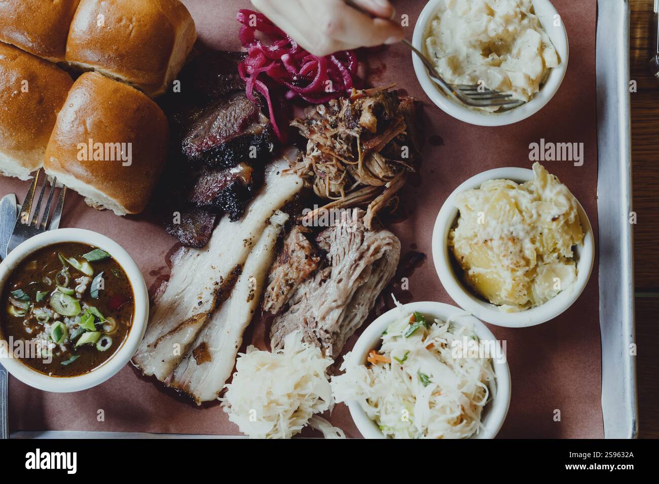 BBQ platter with smoked brisket, pulled pork, ribs, potato salad ...
