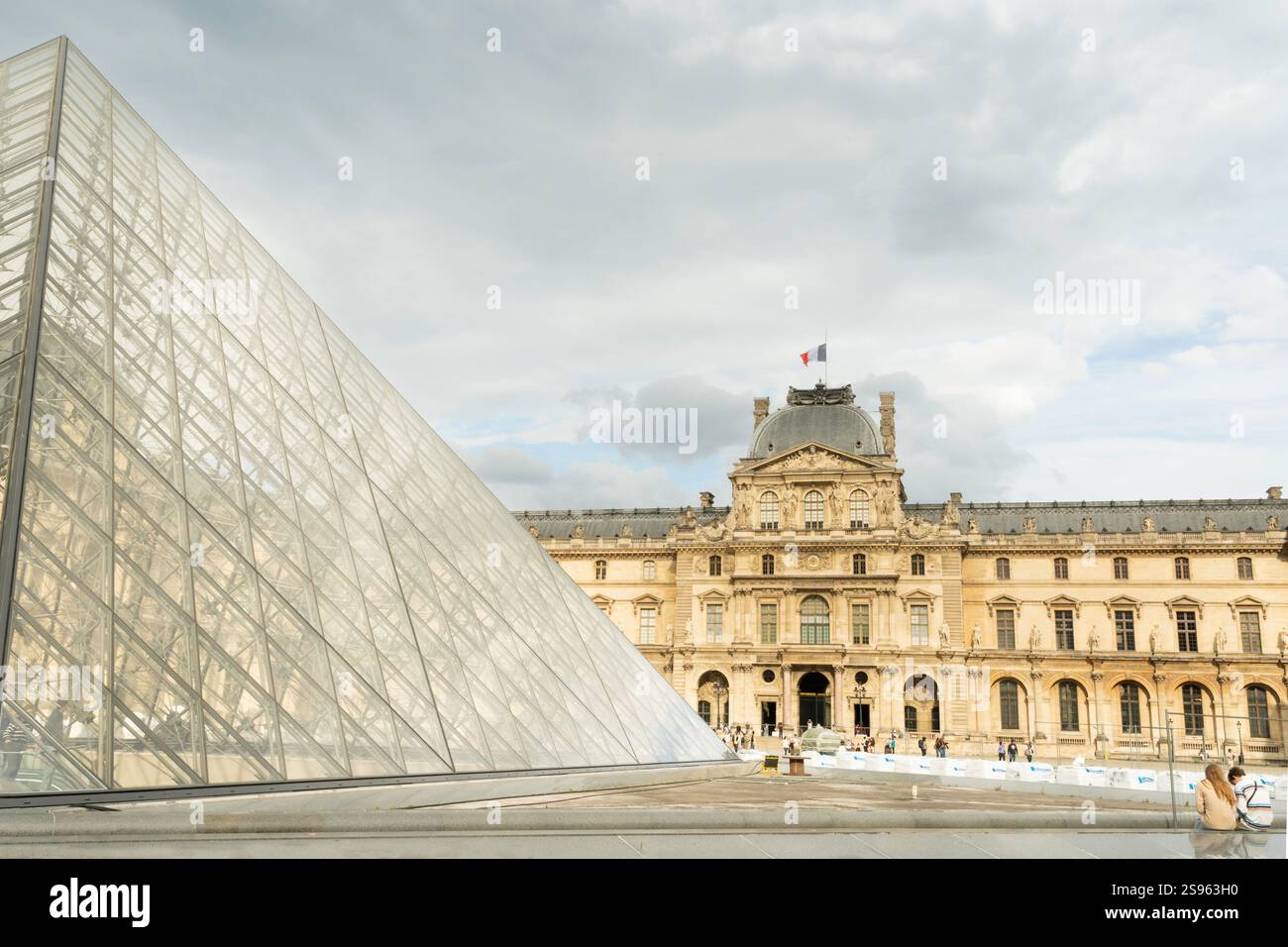 View of Louvre Palace and part of the glass pyramid at Musee de Louvre ...