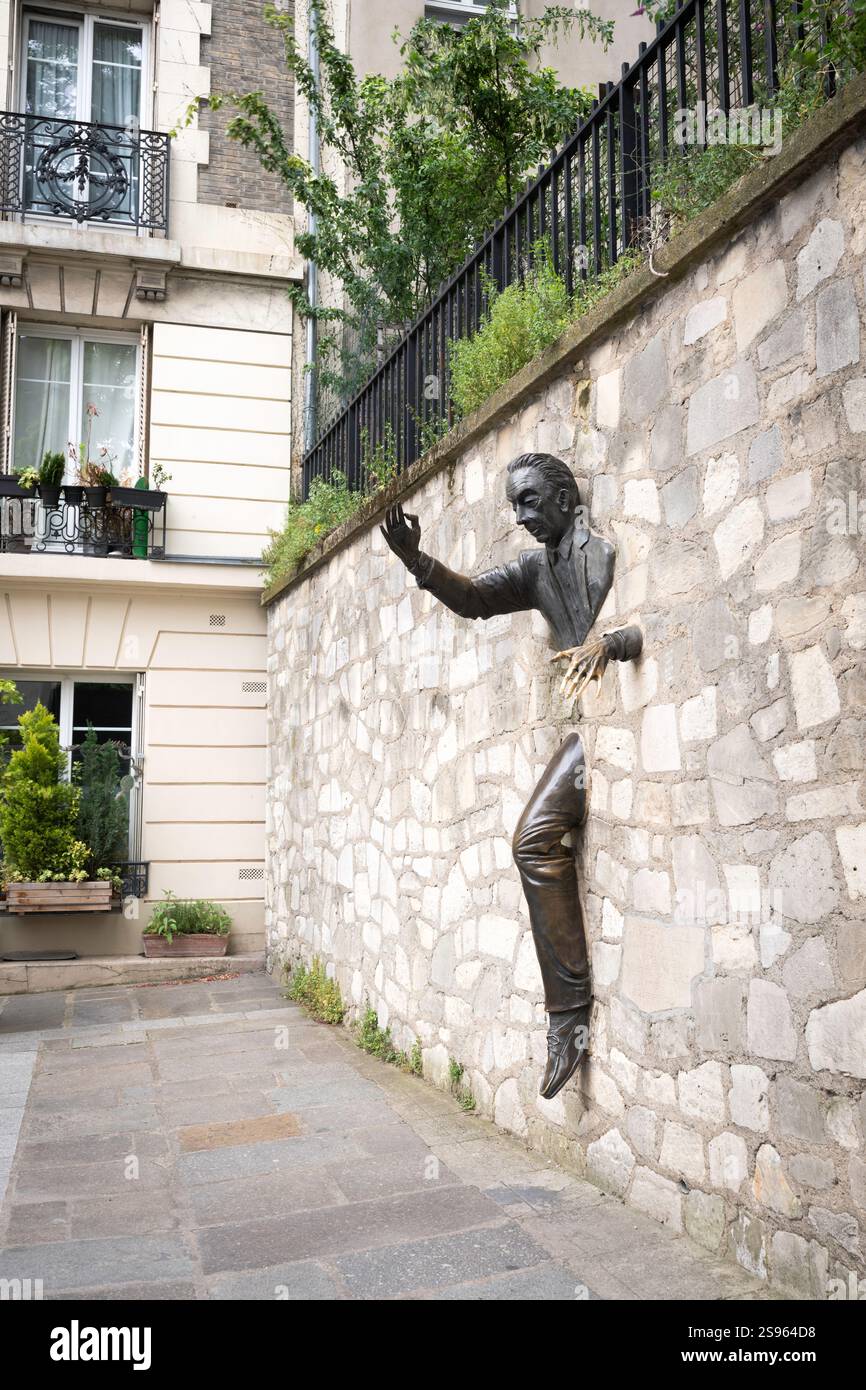 Bronze sculpture of the disappearing man, Montmarte district, Paris ...