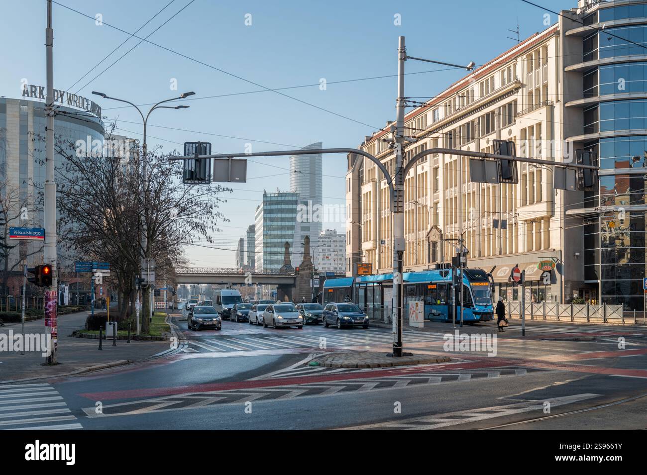 Busy city intersection in Wroclaw on a winter morning with modern glass ...