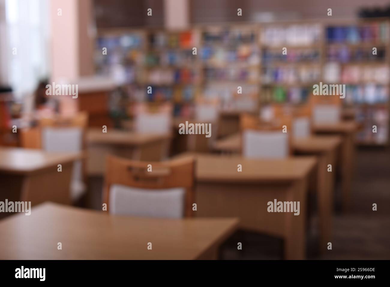 Desks and chairs in public library room, blurred view Stock Photo - Alamy