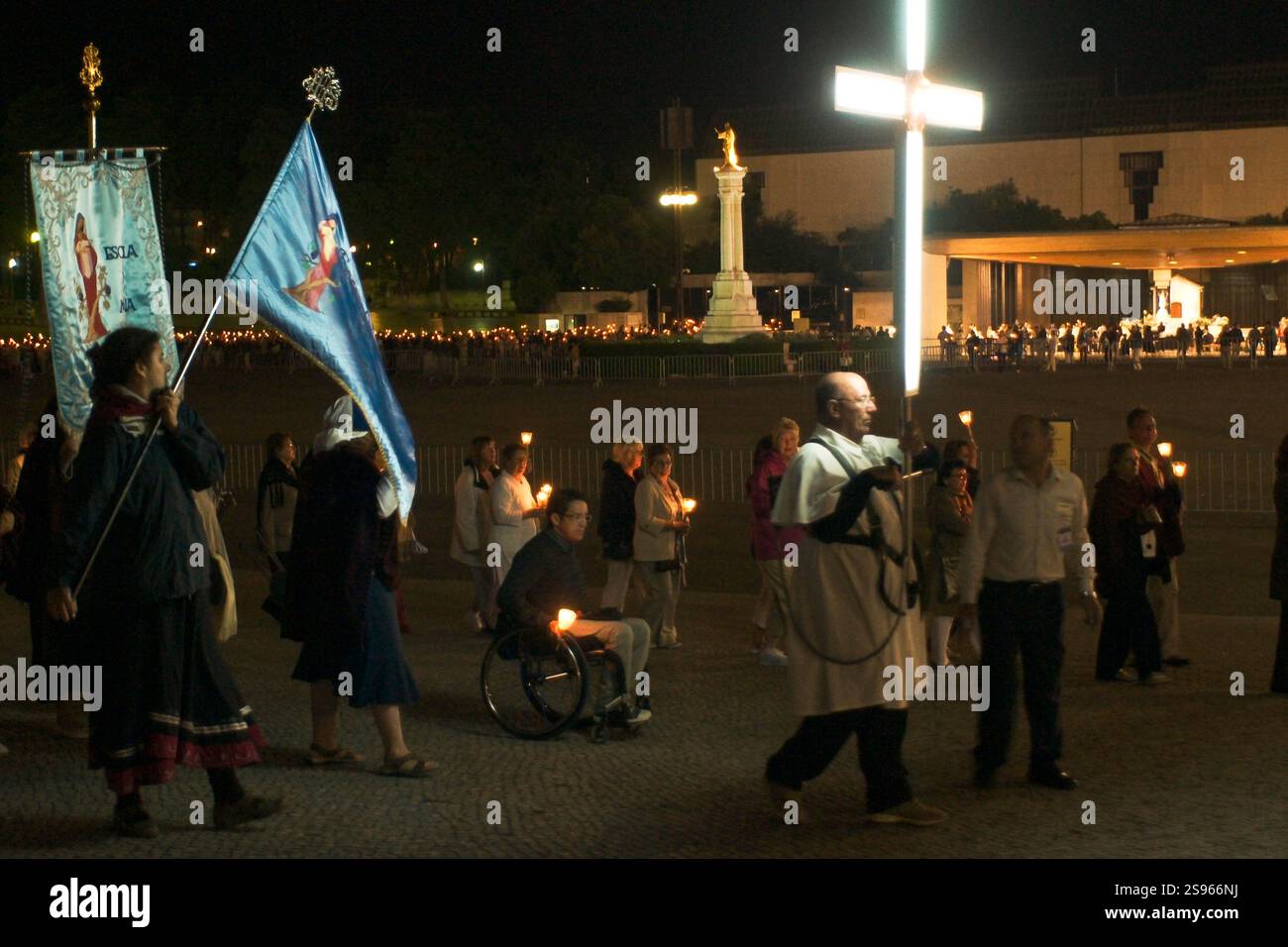 Priest leads the candlelight procession from Chapel of the Apparitions ...