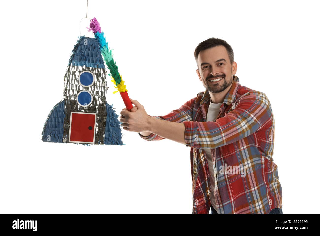 Happy man hitting rocket shaped pinata with stick on white background ...